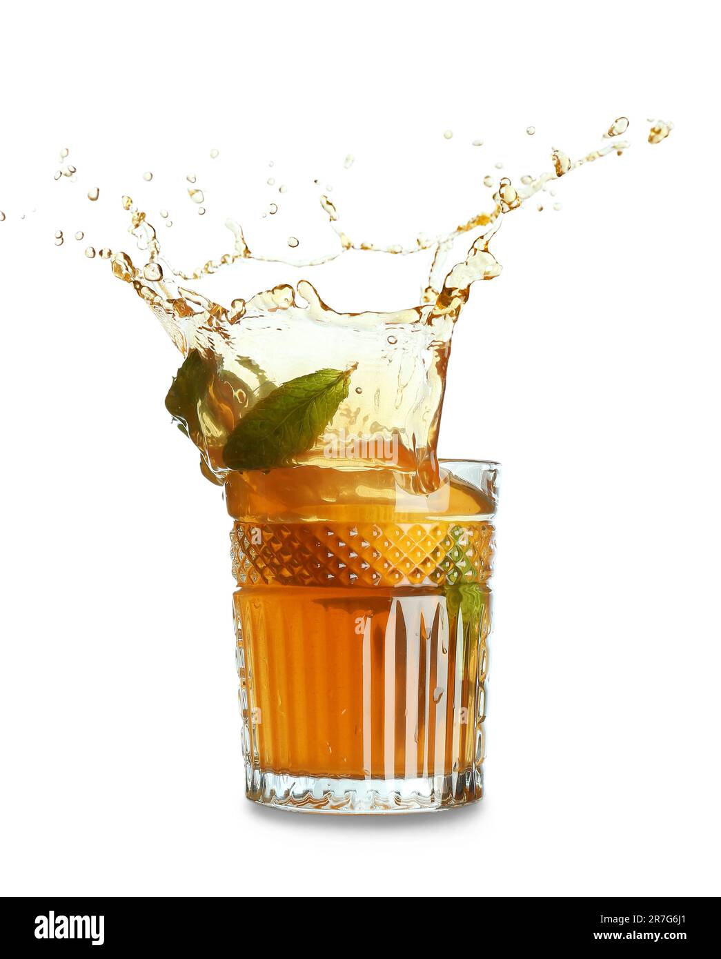 Glass of ice tea with splashes on white background Stock Photo - Alamy