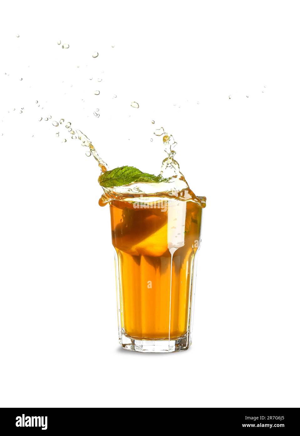 Glass of ice tea with splashes on white background Stock Photo - Alamy