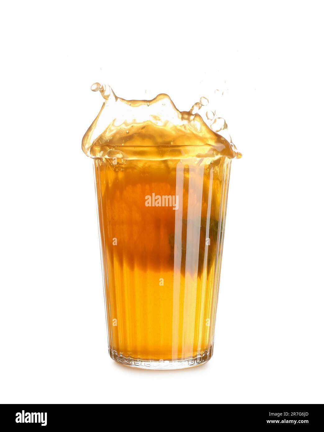 Glass of ice tea with splashes on white background Stock Photo - Alamy