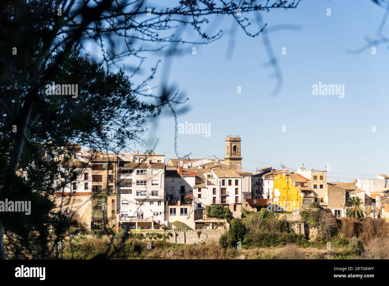 A rural village with a cluster of buildings nestled among trees in the ...
