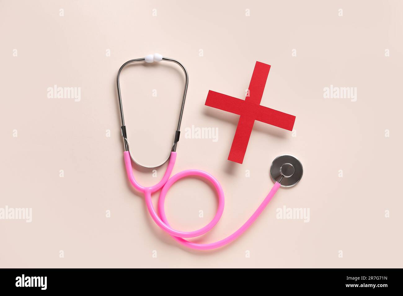 Stethoscope and red cross on light background Stock Photo - Alamy