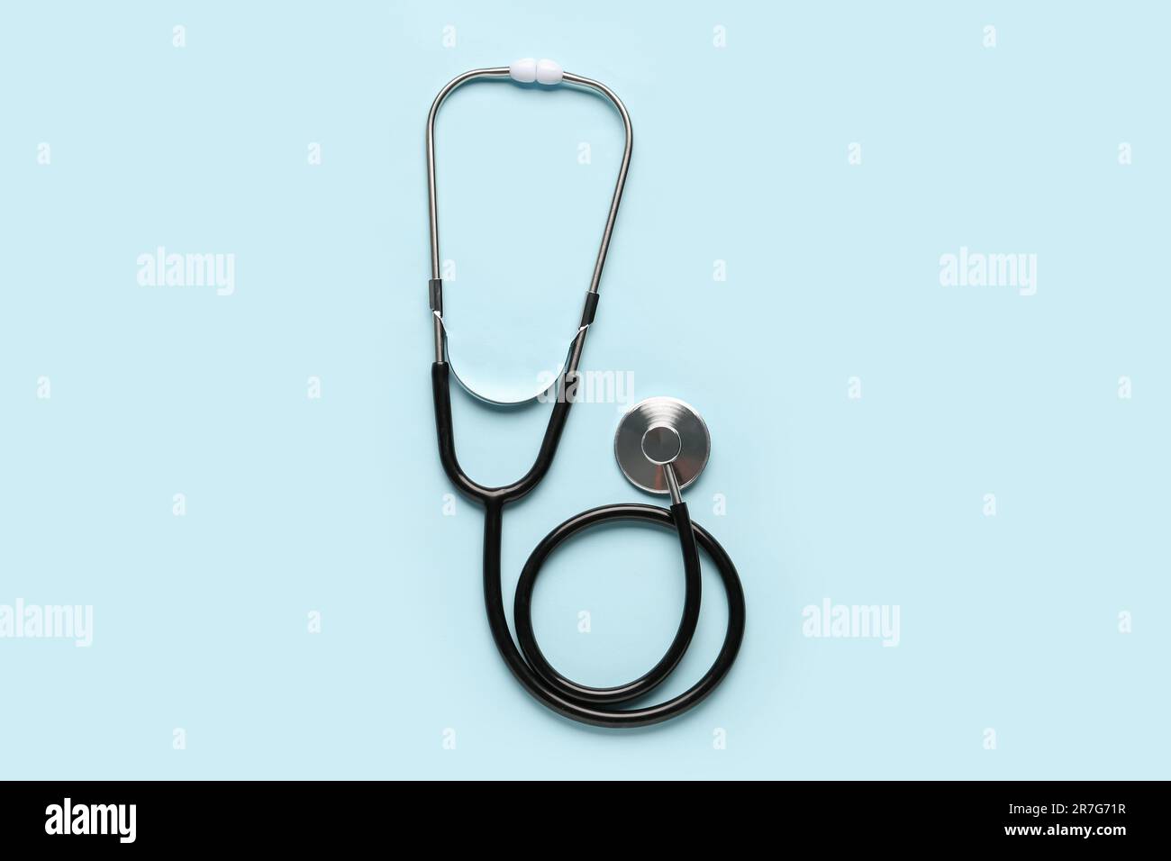 Modern stethoscope on light blue background Stock Photo - Alamy