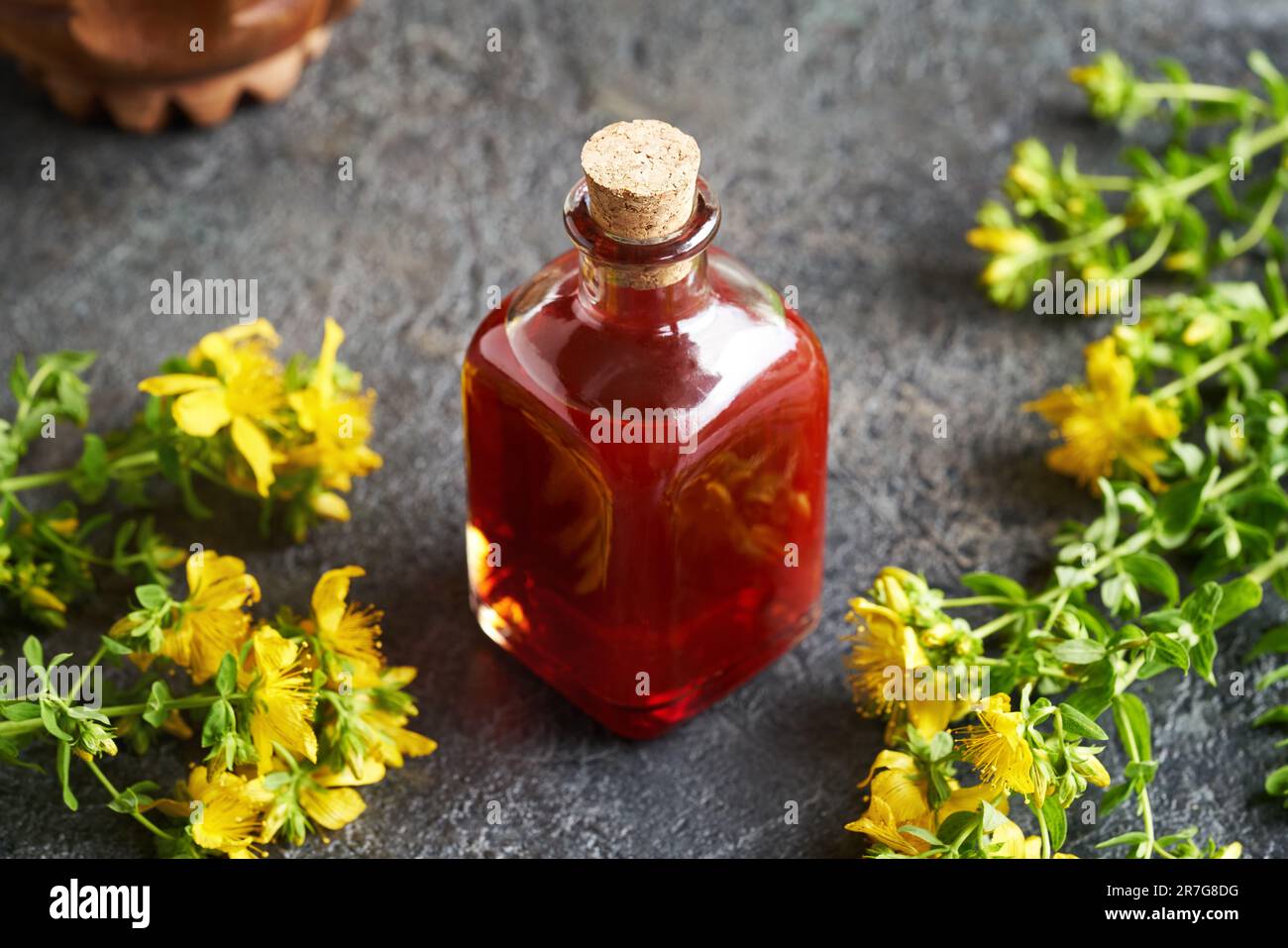 Homemade red oil made from fresh St. John's wort flowers in a glass ...