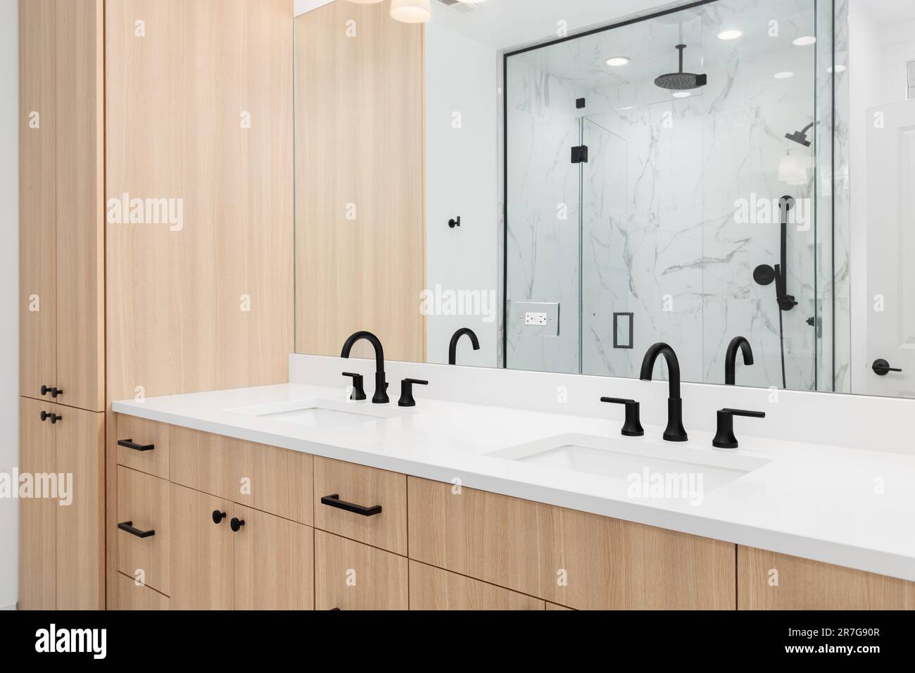 A beautiful bathroom detail with a wood cabinet, white marble ...