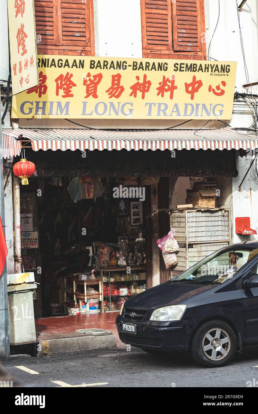 A small independent store located on a street corner, displaying a wide ...