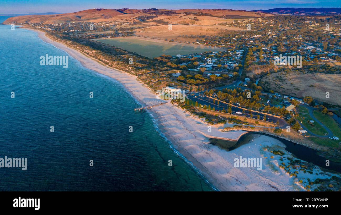A picturesque coastal town with houses near sandy beach of the ocean ...