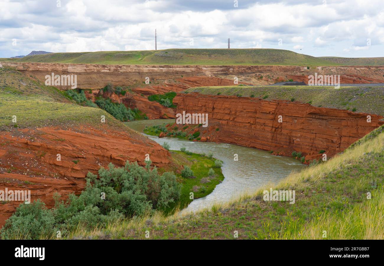 Red sandstone chug water rock forms cliffs in s-curve around Shoshone ...