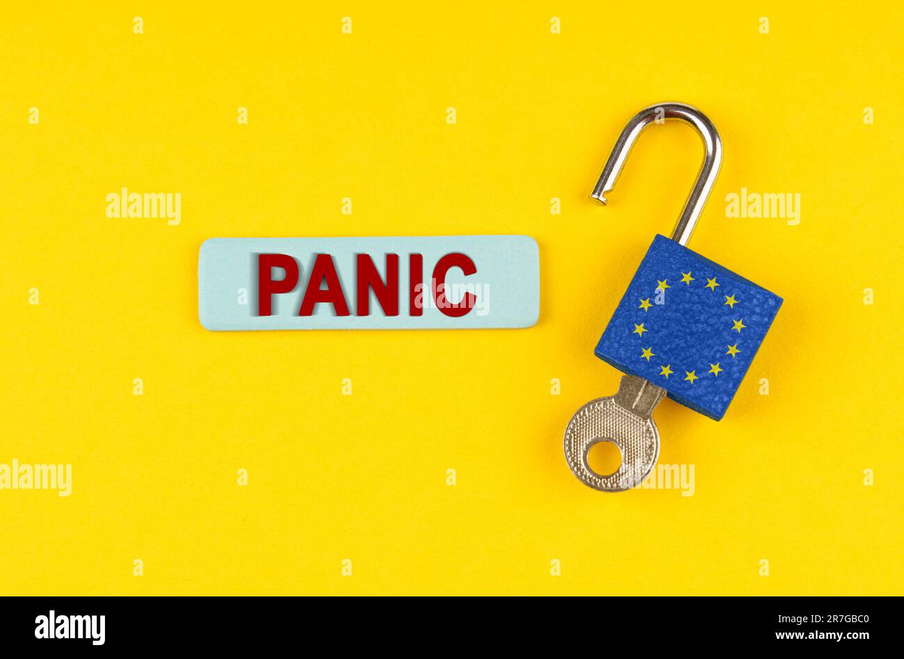 On a yellow surface, an open padlock with the image of the flag of the ...