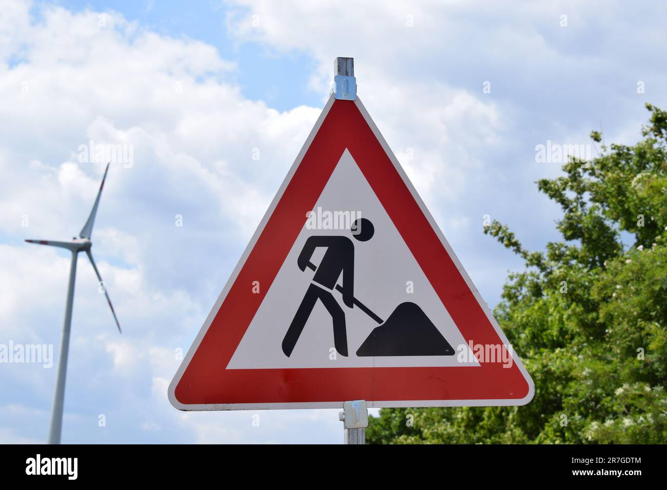 Wind Power Plant next to a road works sign Stock Photo - Alamy
