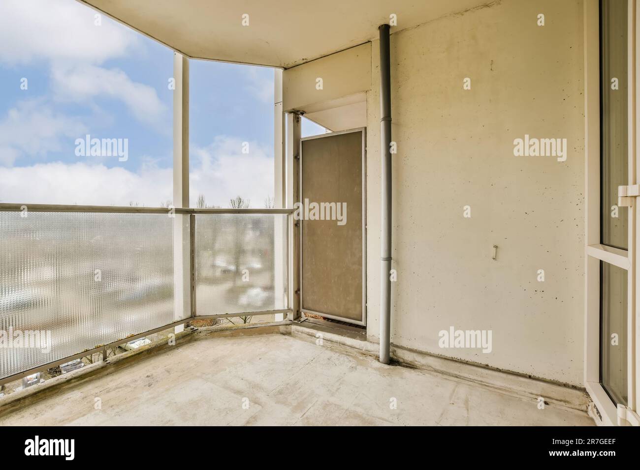 an empty balcony with blue sky and white clouds in the background ...