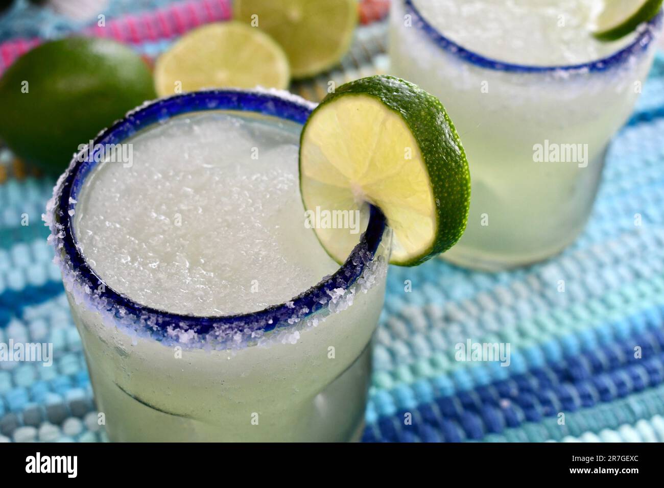 Margarita in a blue rimmed glass, salted with lime slice garnish Stock ...