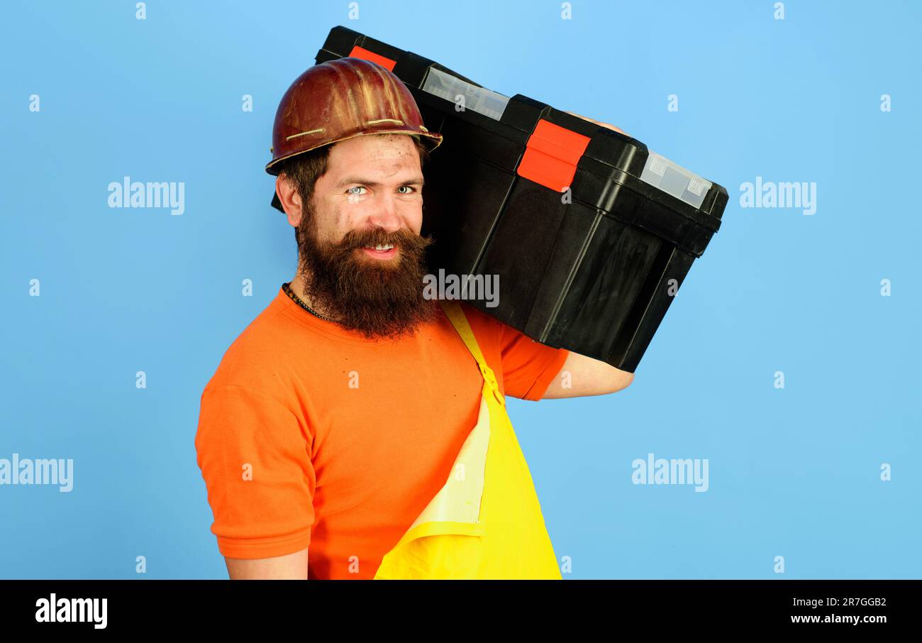 Repairman in hardhat with toolbox. Builder with box for instruments ...