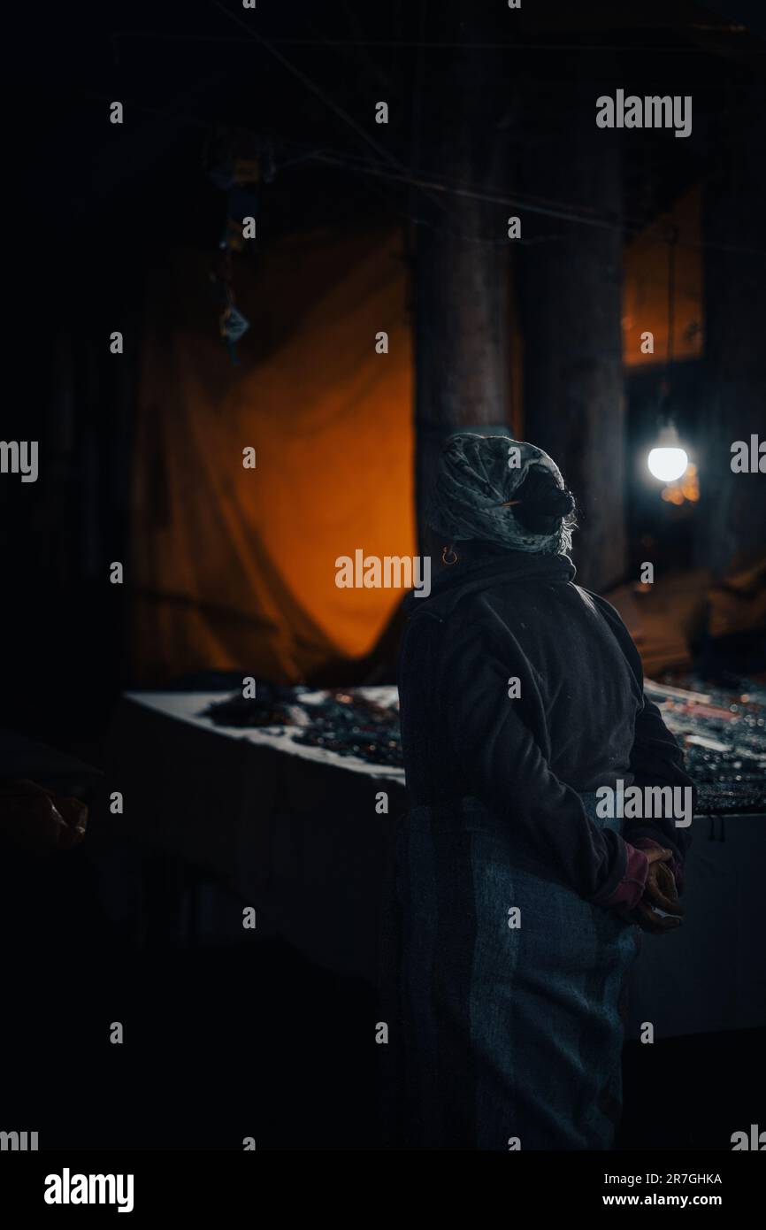 An old lady is standing next to a table with jewelry Stock Photo - Alamy