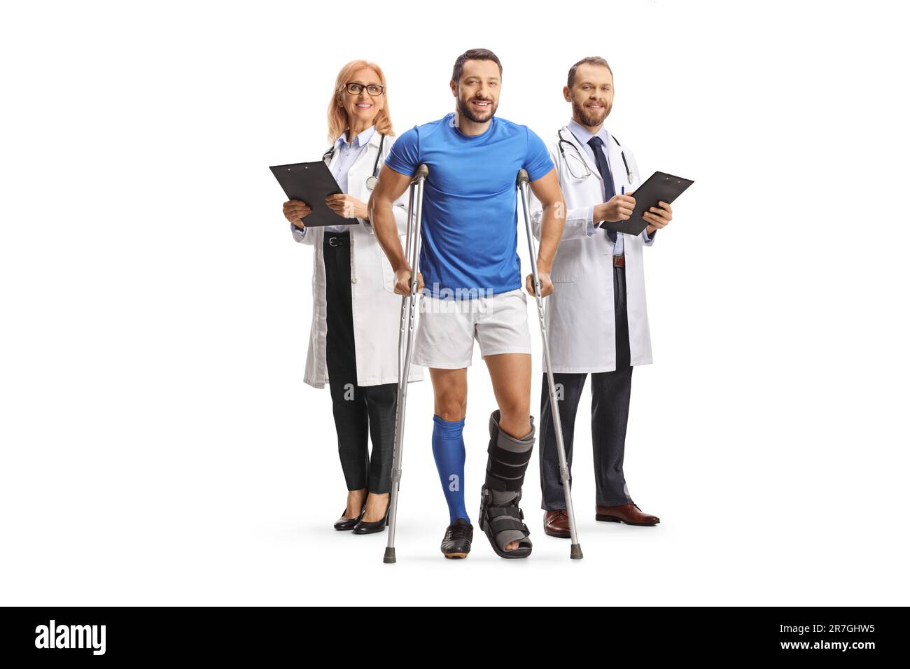Male athlete with a leg injury standing with crutches in front of a ...