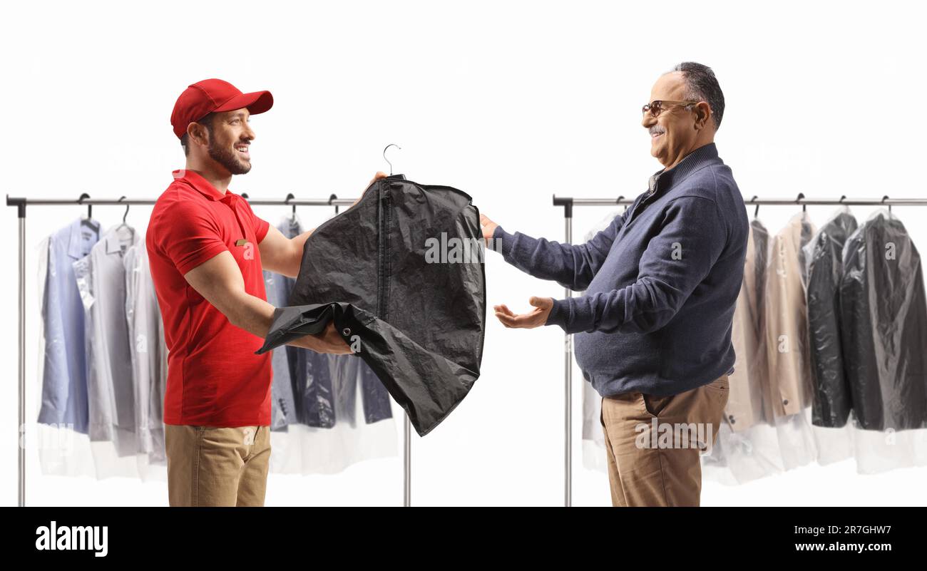 Laundry worker giving a suit with a cover case to a mature man in front ...