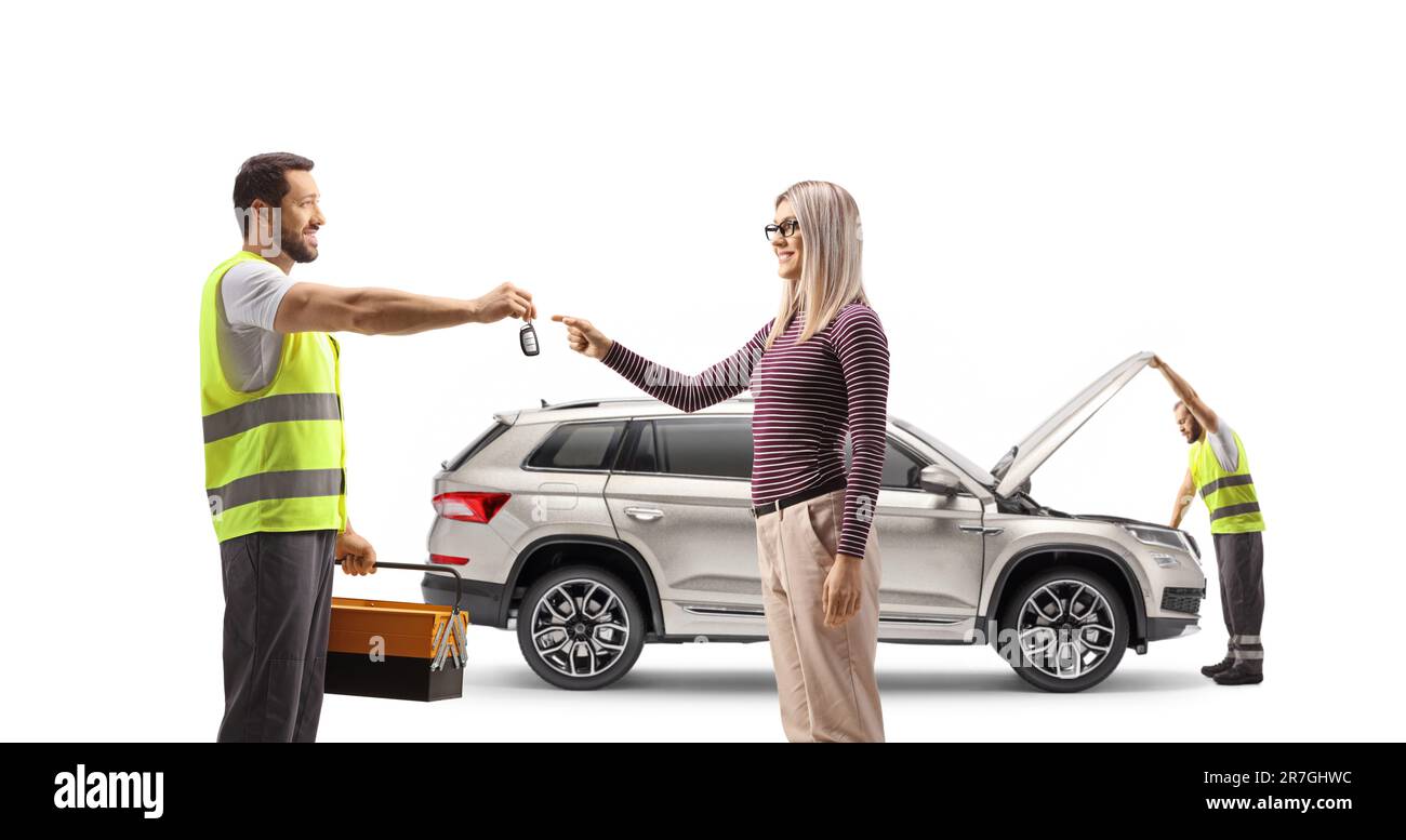 Road assistance agent giving SUV keys to a woman isolated on white ...