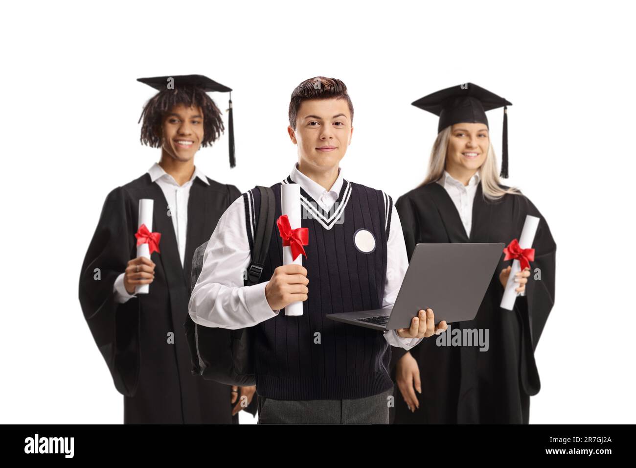 Schoolboy with a laptop computer posing with graduate students isolated ...