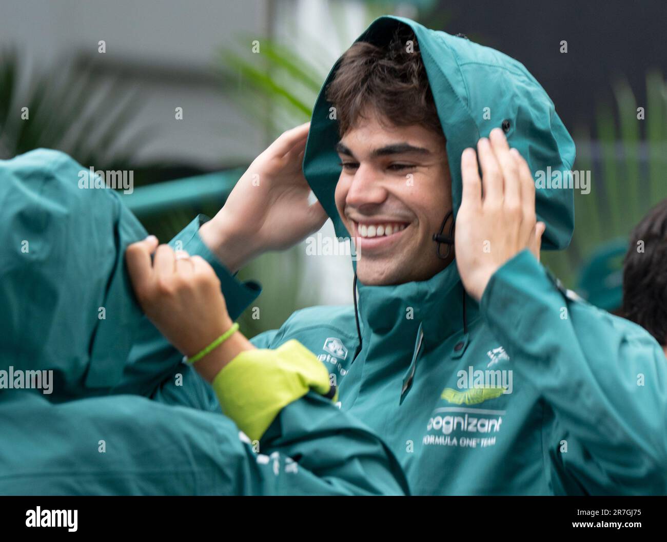Aston Martin driver Lance Stroll, from Canada, puts on his rain jacket ...