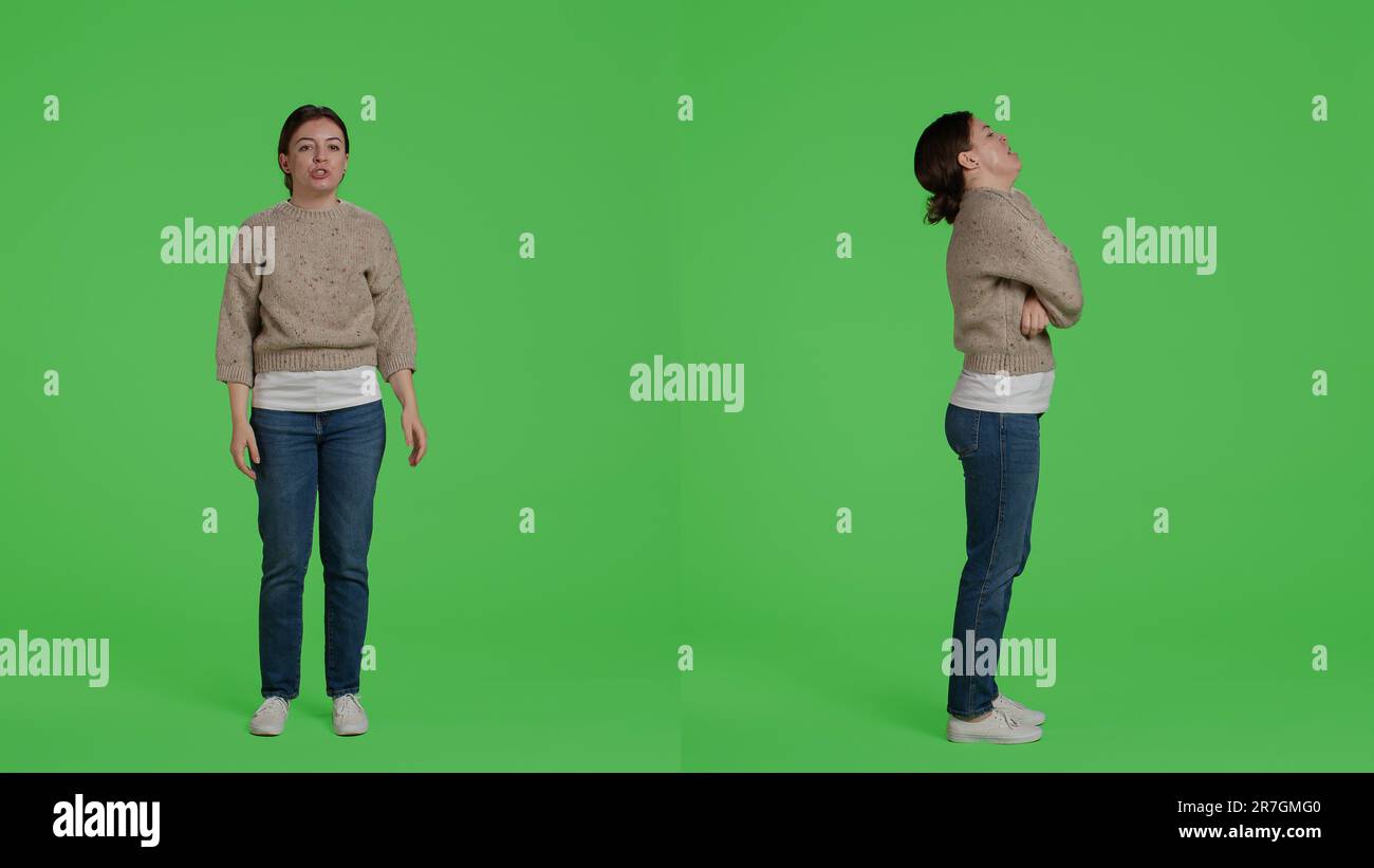 Angry displeased woman standing on full body green screen, showing ...