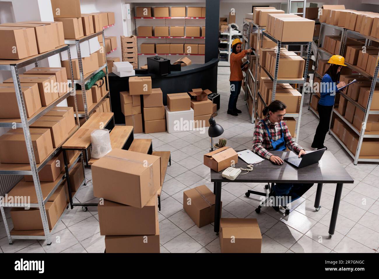 Asian postal service team doing inventory in industrial warehouse ...