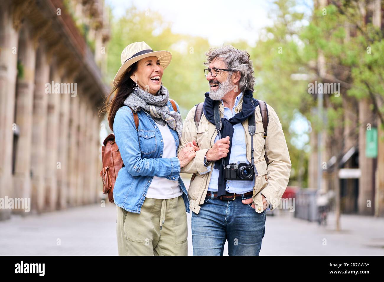 Happy older couple having fun walking outdoors in city. Retired people ...