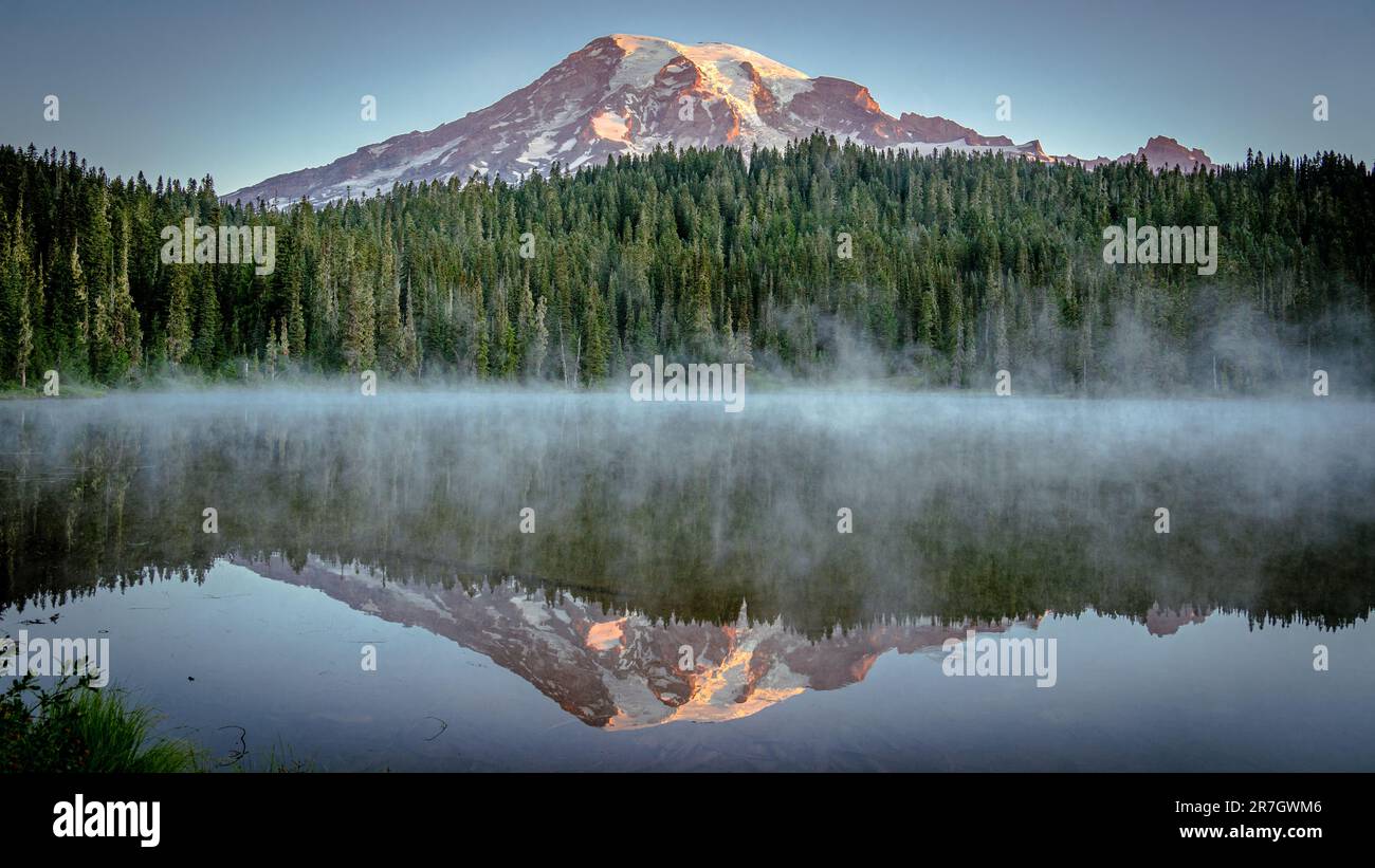 Mount Rainier and pine forest reflecting into Reflection Lakes at ...