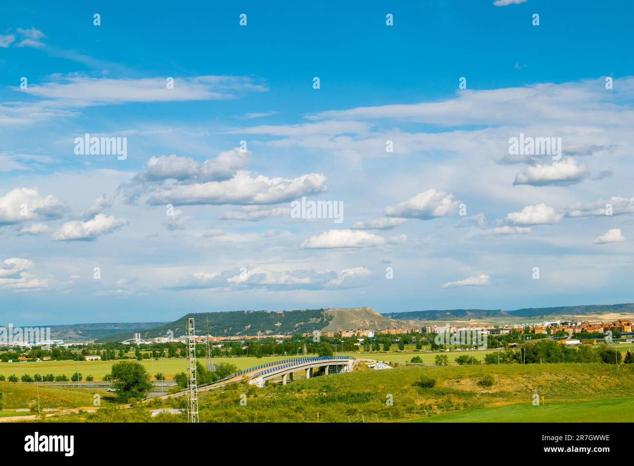 A beautiful landscape with green trees on horizon against cloudy blue ...