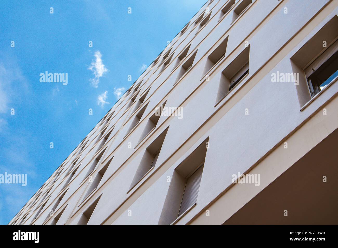 A beige facade of a modern multistory residential building, house view ...