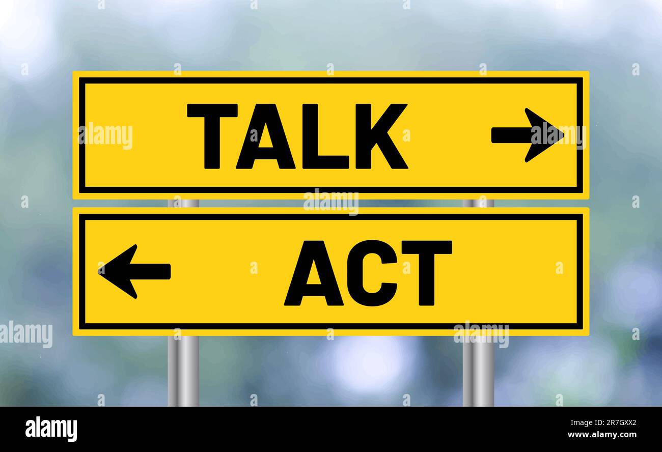 Talk or act road sign on blur background Stock Photo - Alamy