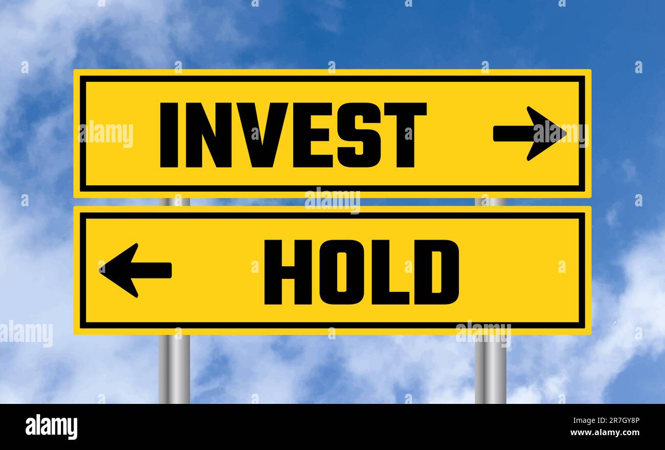 Invest or hold road sign on sky background Stock Photo - Alamy