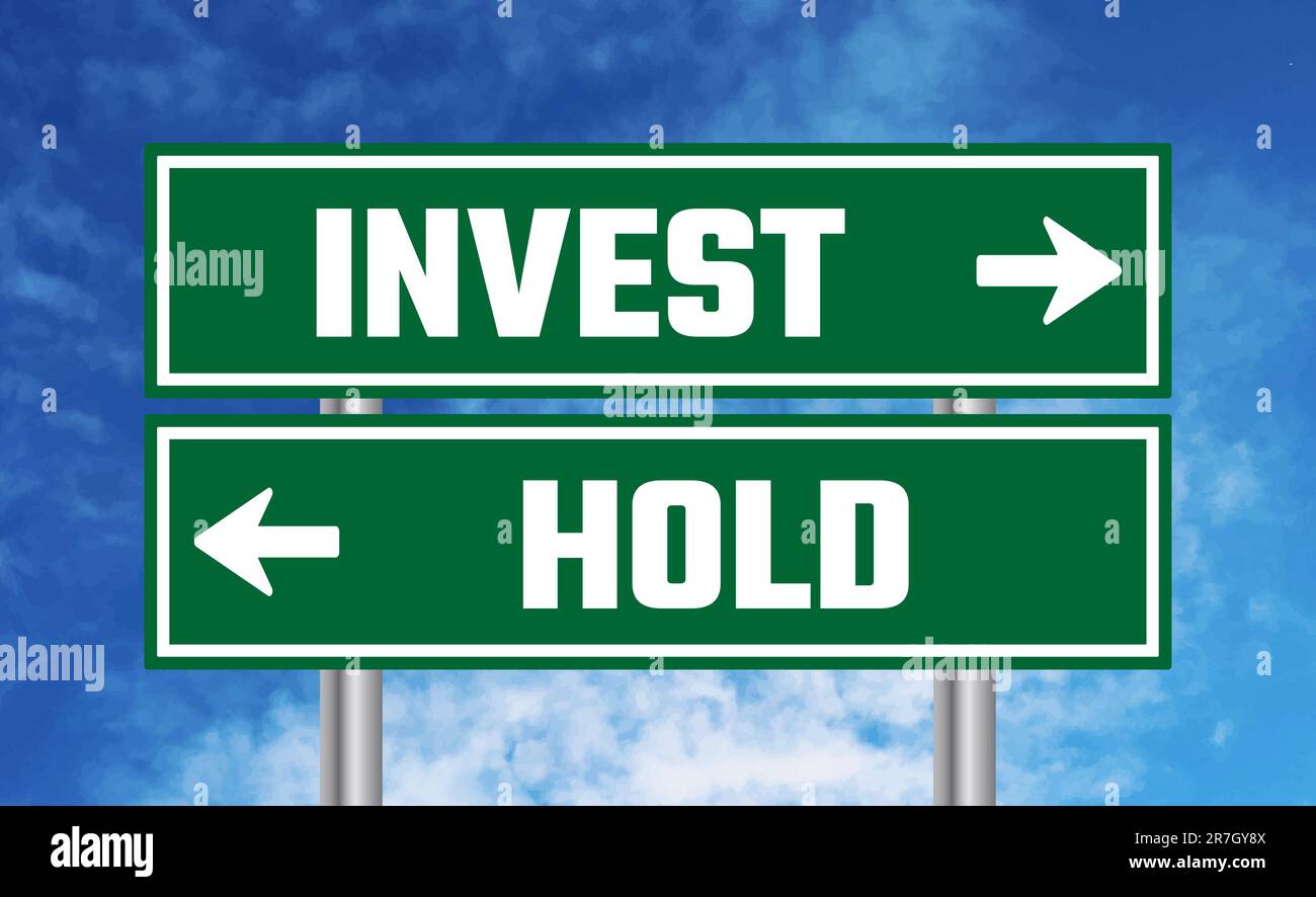 Invest or hold road sign on sky background Stock Photo - Alamy