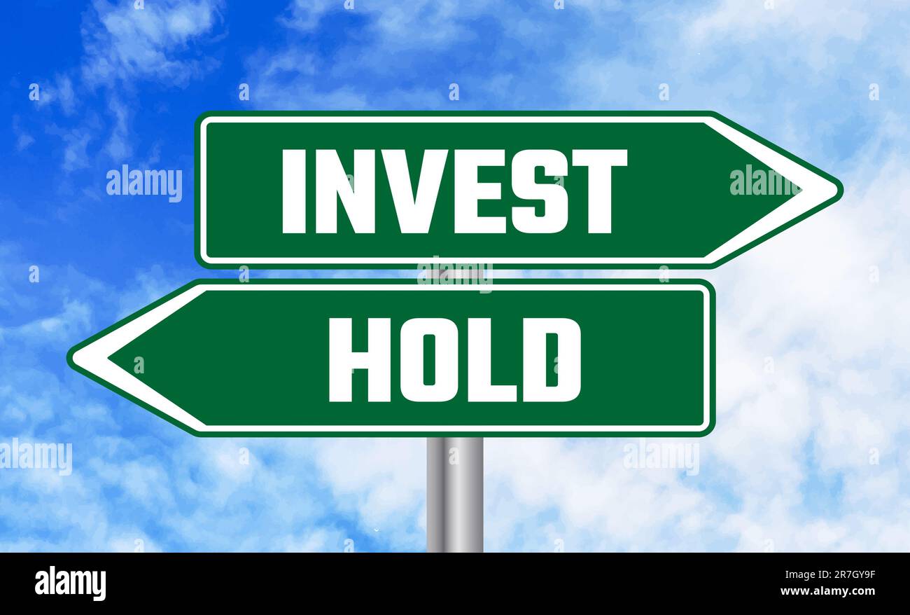 Invest or hold road sign on sky background Stock Photo - Alamy