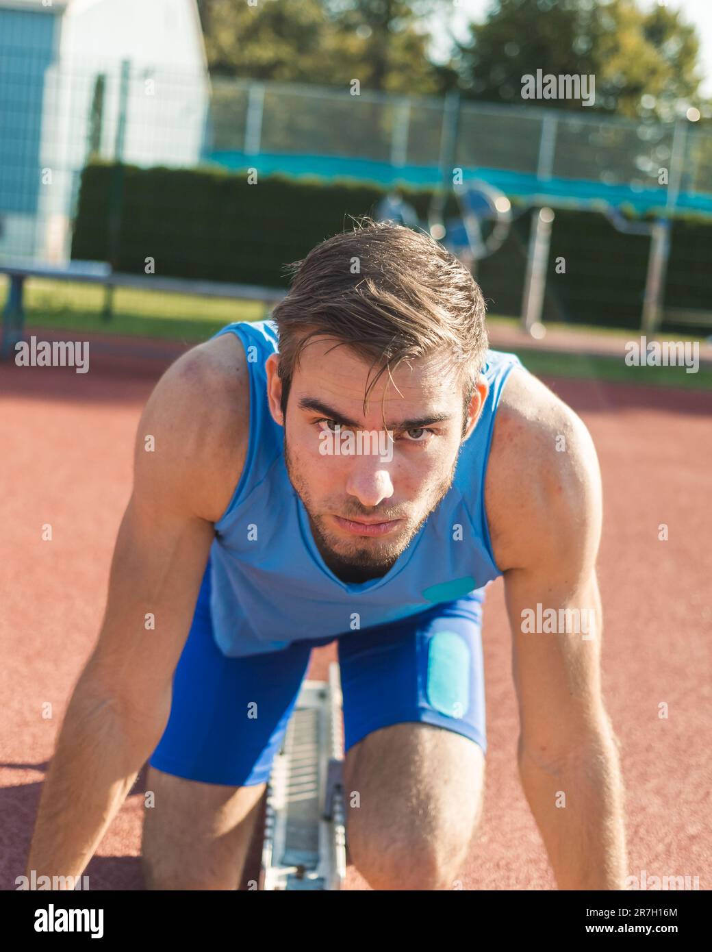 Focused young professional male Caucasian athlete ready for the run ...