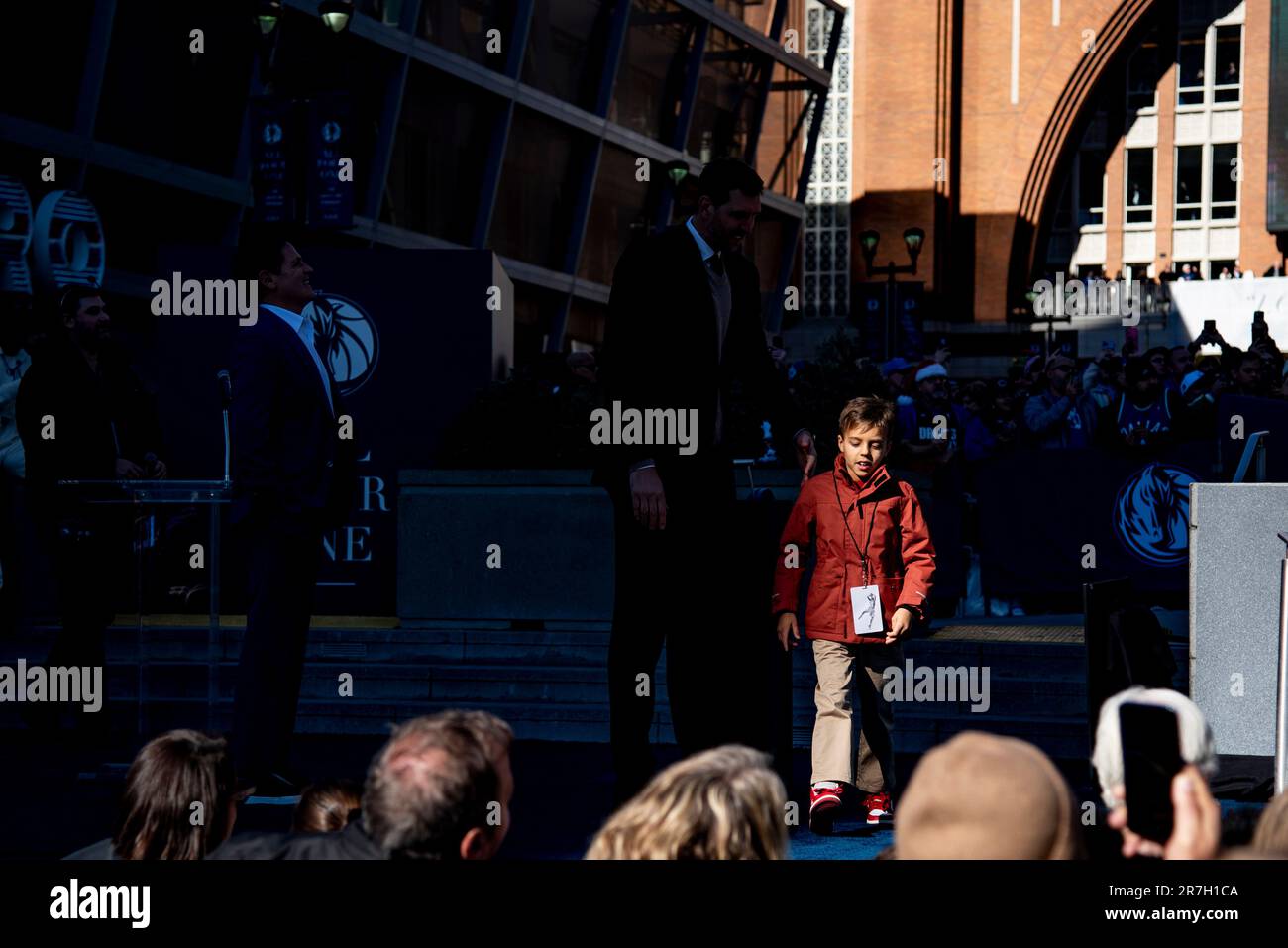 Max Nowitzki walks back to his seat after helping his father, Dirk ...