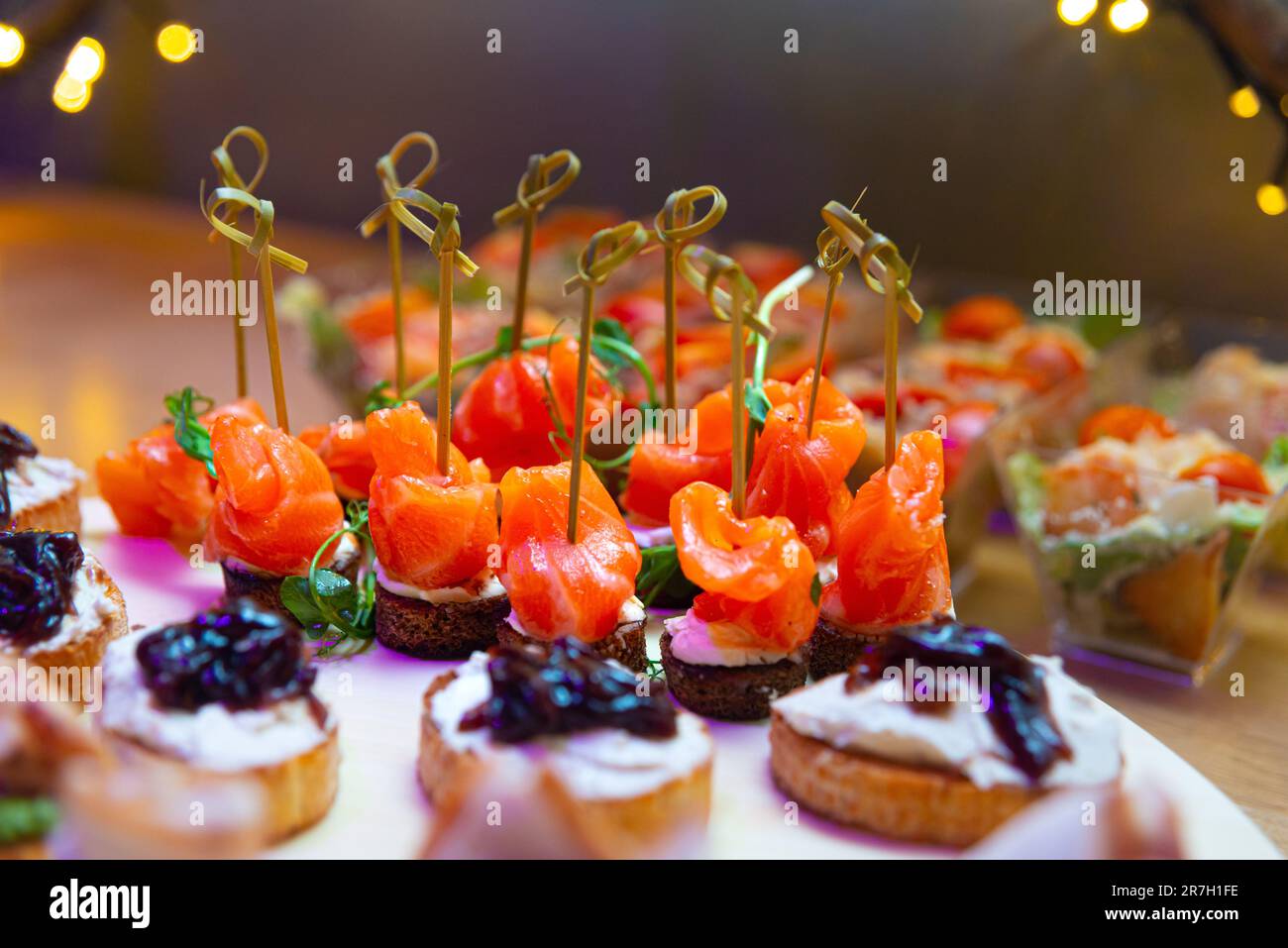 Canapes with salmon, microgreens and cream cheese spread on rye bread ...