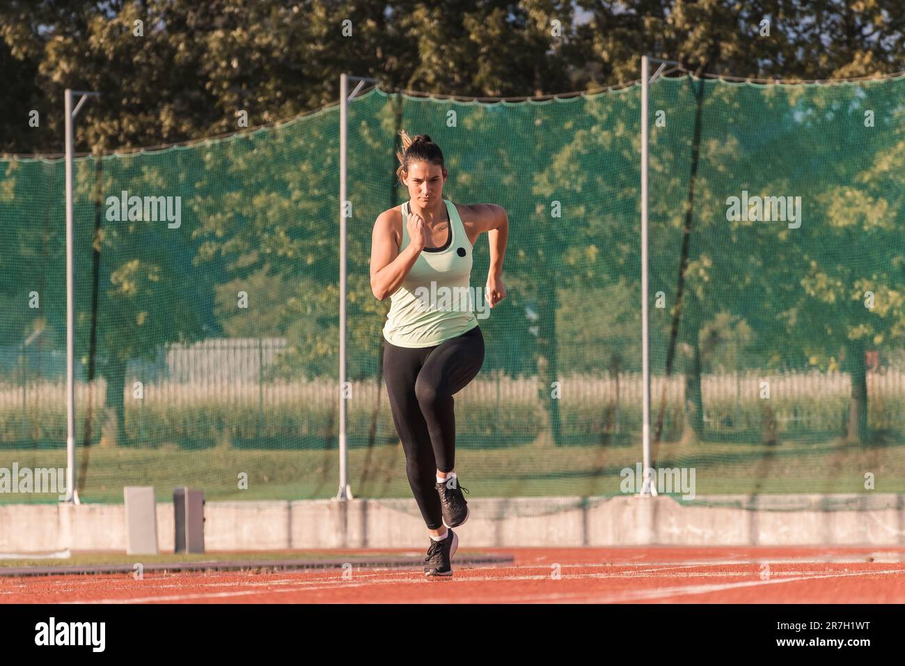Athlete woman starting to run on the athletic track from the three ...