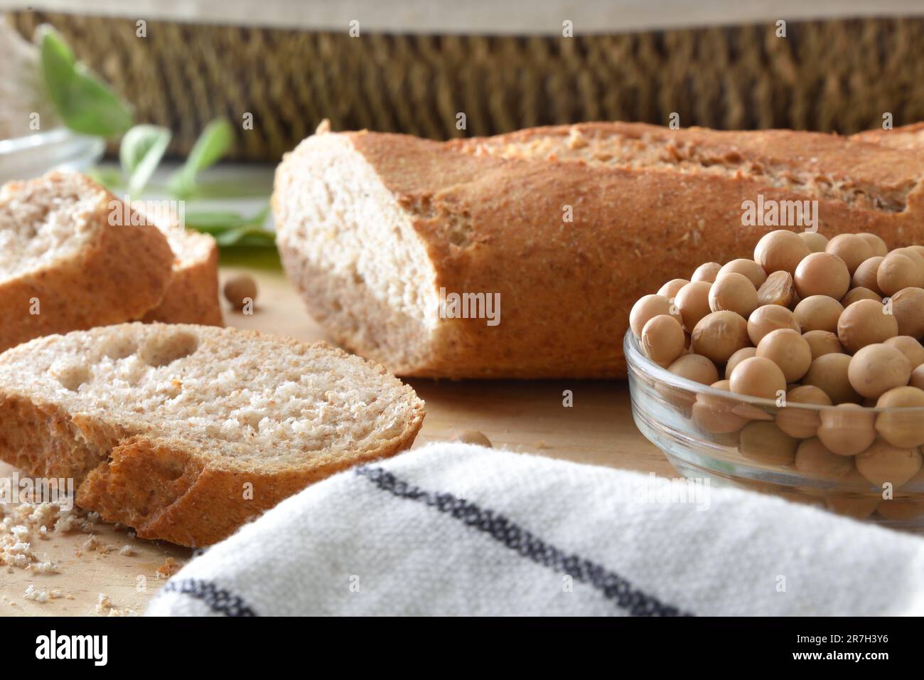Detail of soy flour bread and grains on wooden bench in a kitchen ...