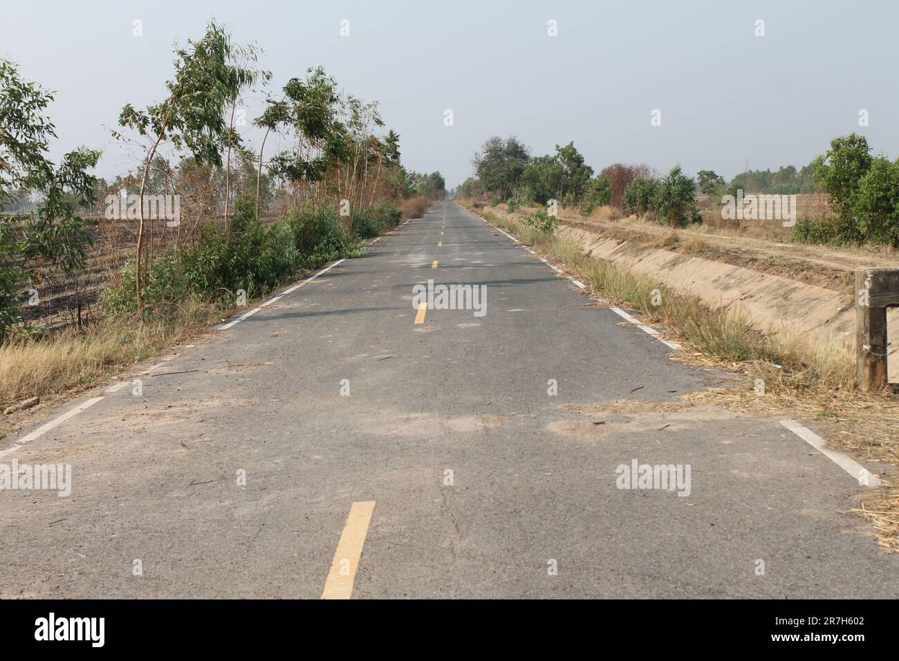 Paved road beside a canal without water during the day Stock Photo - Alamy