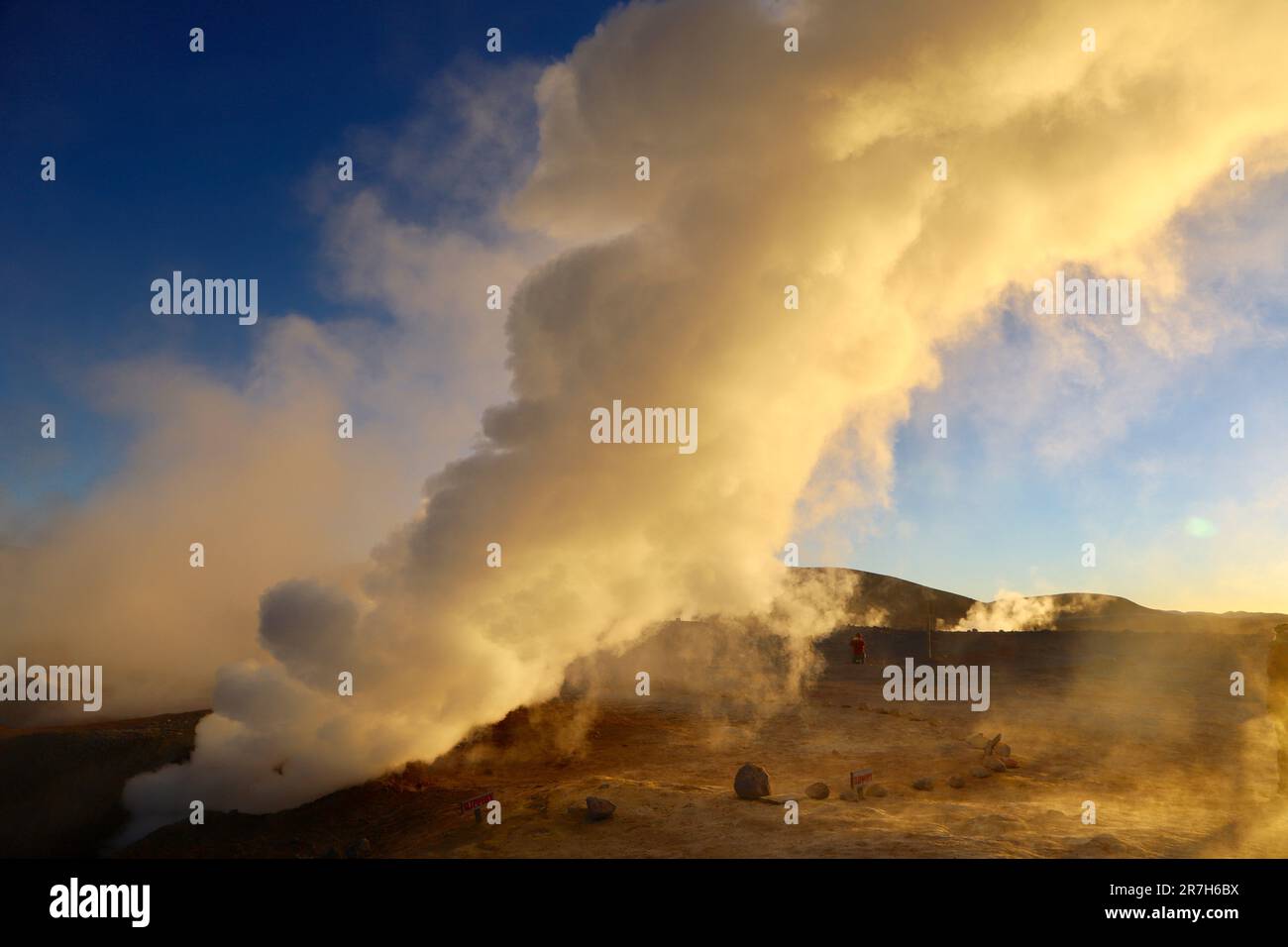 A single wisp of vapor hovers in the air of an arid desert, creating a ...