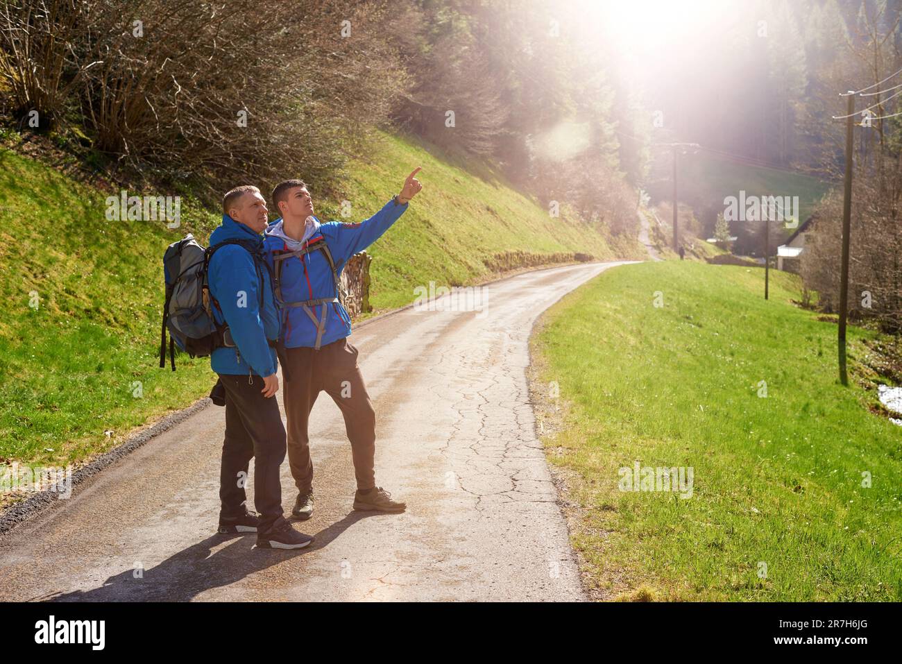 Two hikers are in the mountains in the spring nature outdoor. Hiking ...