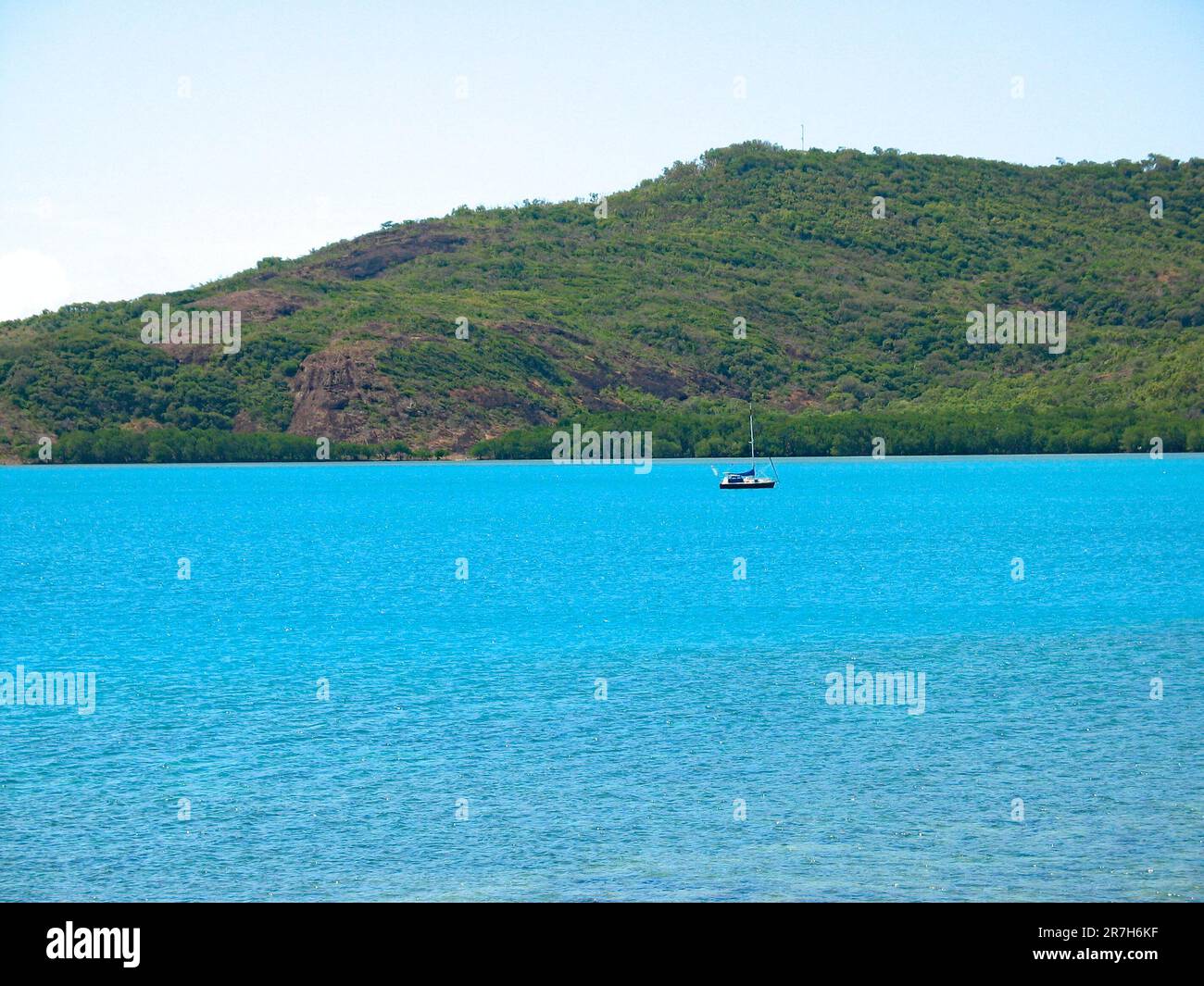 Small sailing boat anchored in the bay of Mt Adolphus Island, Torres ...