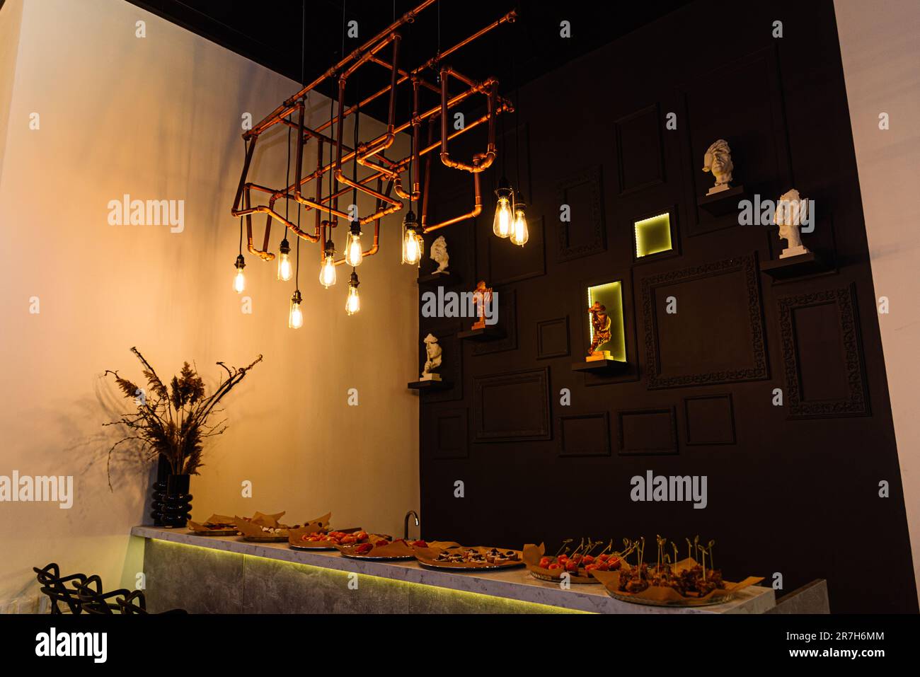 retro lamps with a warm glow on copper tubes under the ceiling, shining ...