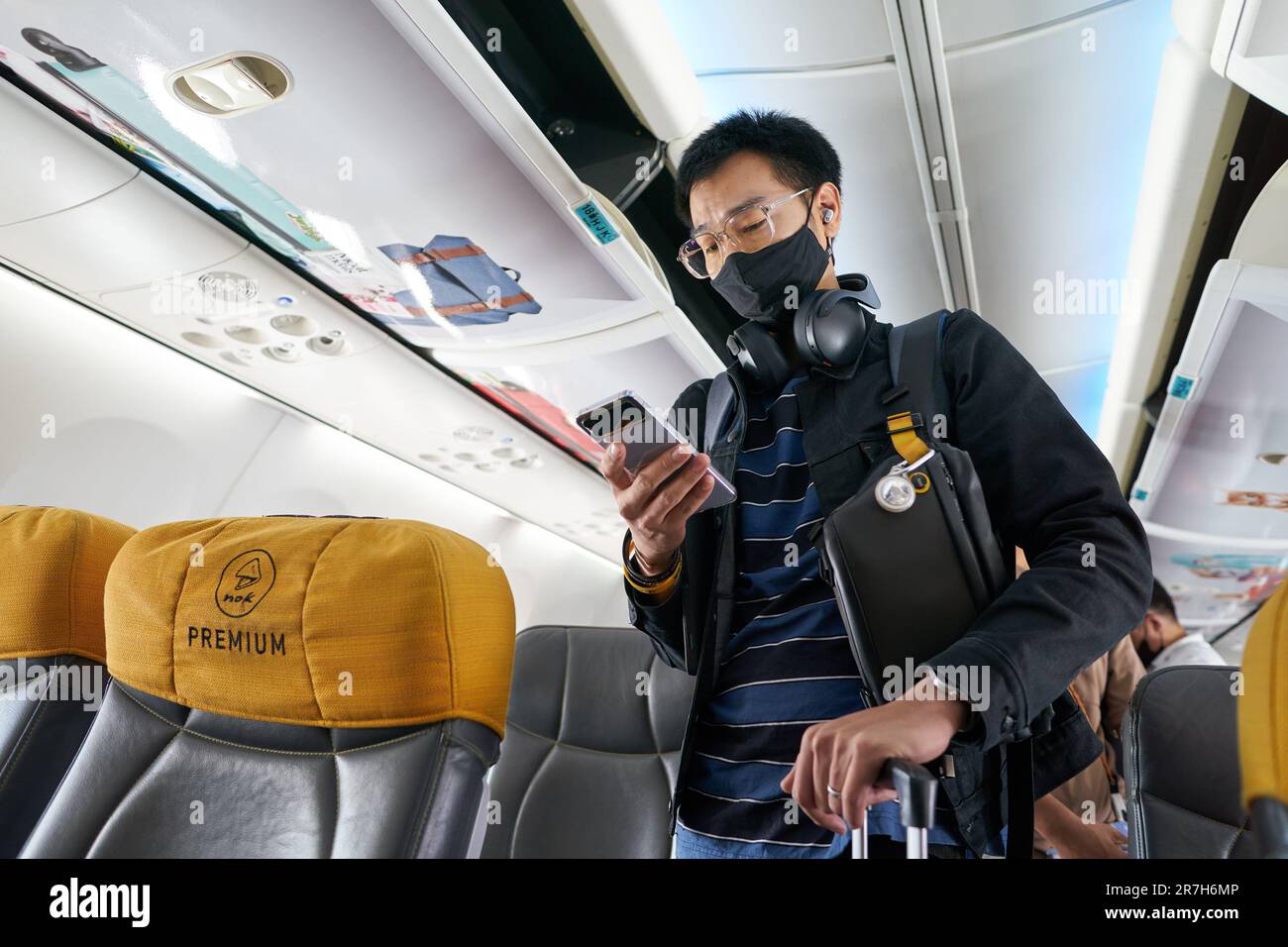 CHIANG MAI, THAILAND - CIRCA APRIL, 2023: man standing in the aisle at ...