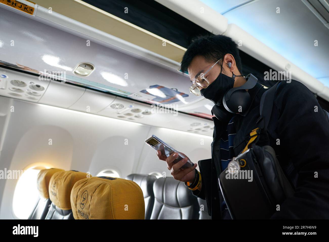 CHIANG MAI, THAILAND - CIRCA APRIL, 2023: man standing in the aisle at ...