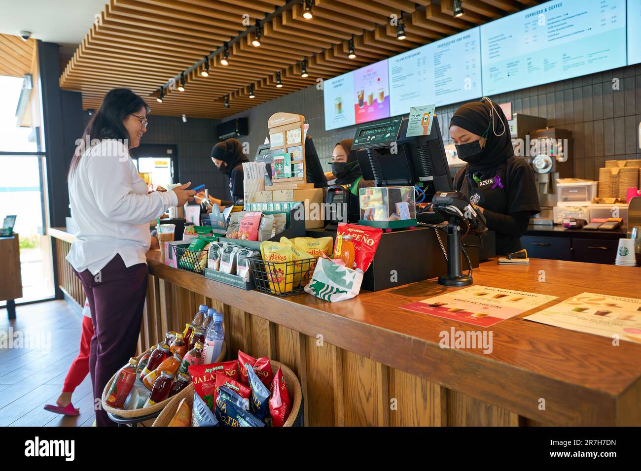 KUALA LUMPUR, MALAYSIA - CIRCA MARCH, 2023: woman ordering coffee at Starbucks Coffee in Kuala ...