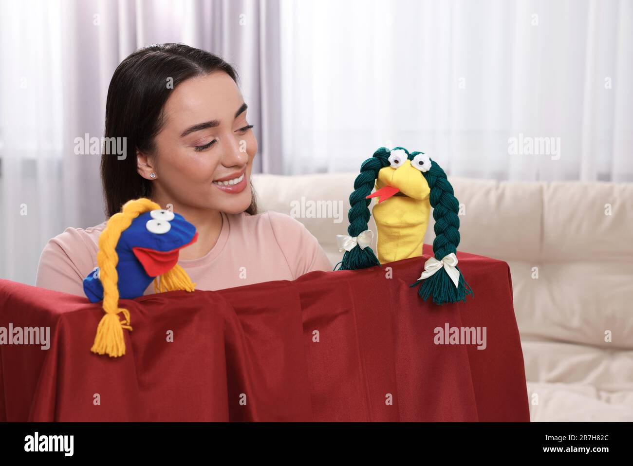 Happy woman performing puppet show at home Stock Photo - Alamy