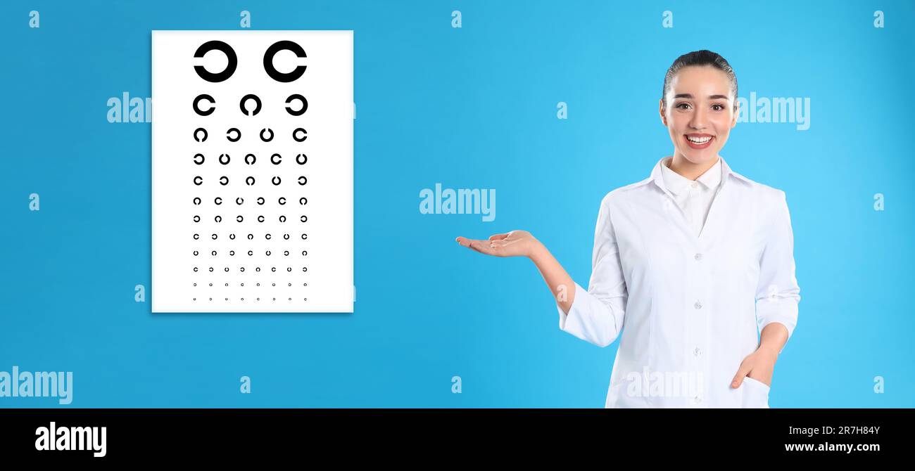Vision test. Ophthalmologist or optometrist pointing at eye chart on ...