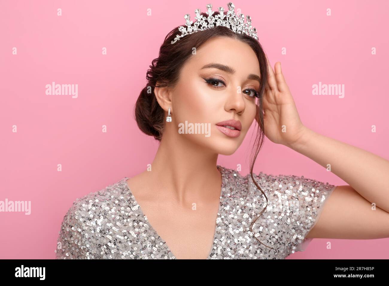 Beautiful young woman wearing luxurious tiara on pink background Stock Photo - Alamy