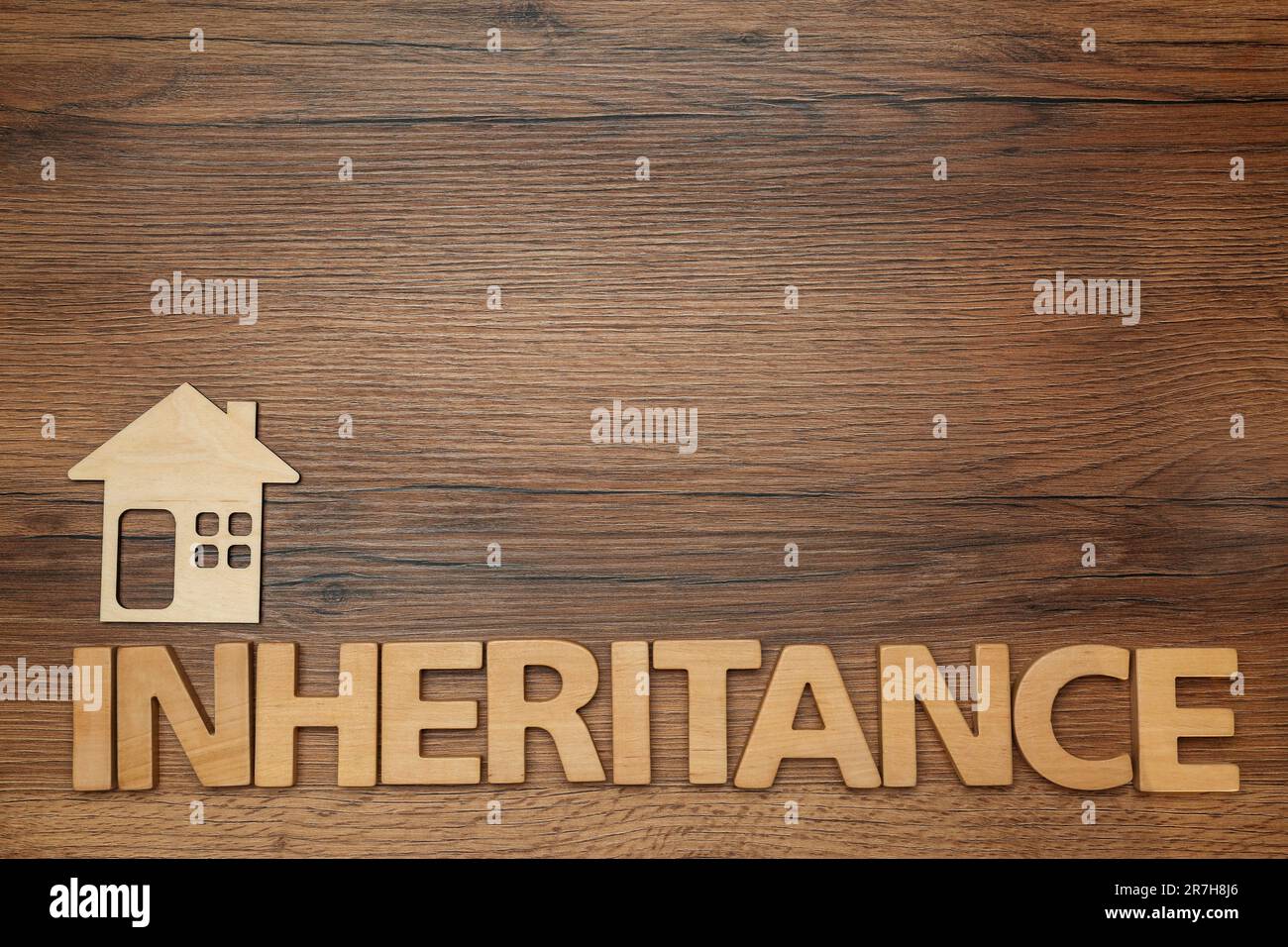 Word Inheritance made with letters and house model on wooden background ...