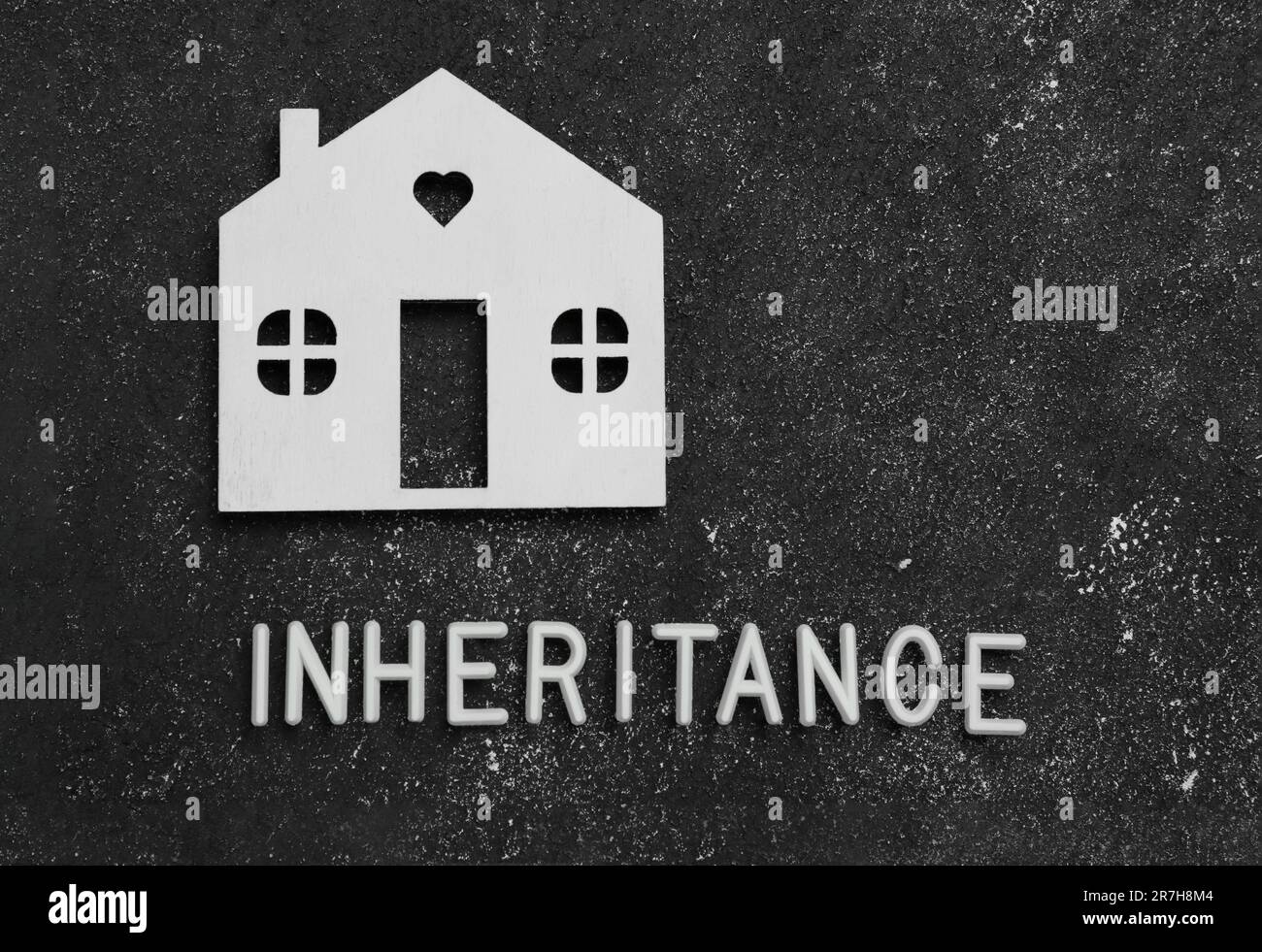 Word Inheritance made with letters and house model on black background ...